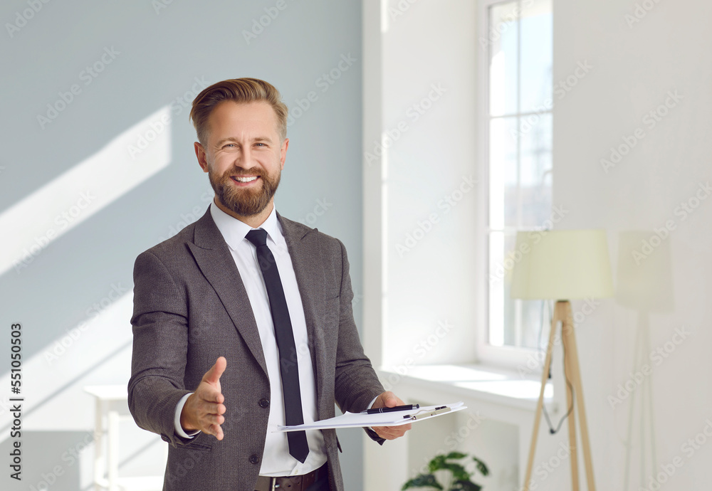 Friendly real estate agent greeting you inside new house. Portrait of ...