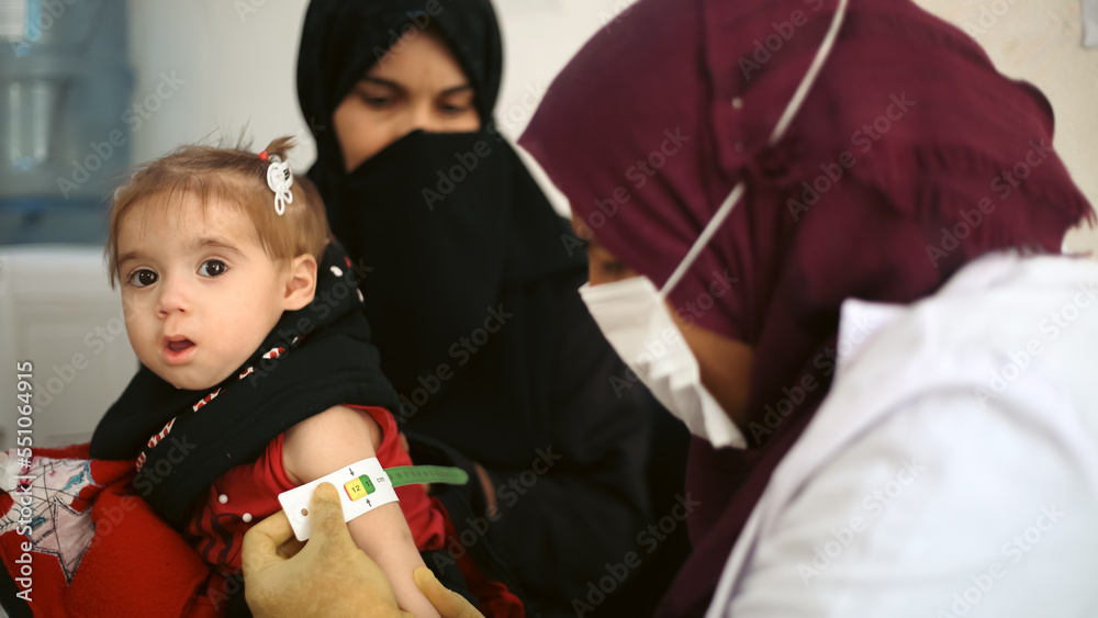 Doctor examines child malnutrition. Measuring malnutrition using strap ...
