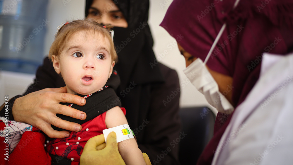 Doctor examines child malnutrition. Measuring malnutrition using strap ...