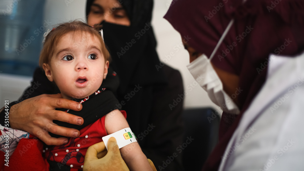 Doctor examines child malnutrition. Measuring malnutrition using strap ...