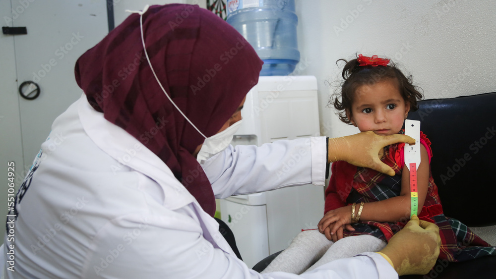 Doctor examines child malnutrition. Measuring malnutrition using strap ...