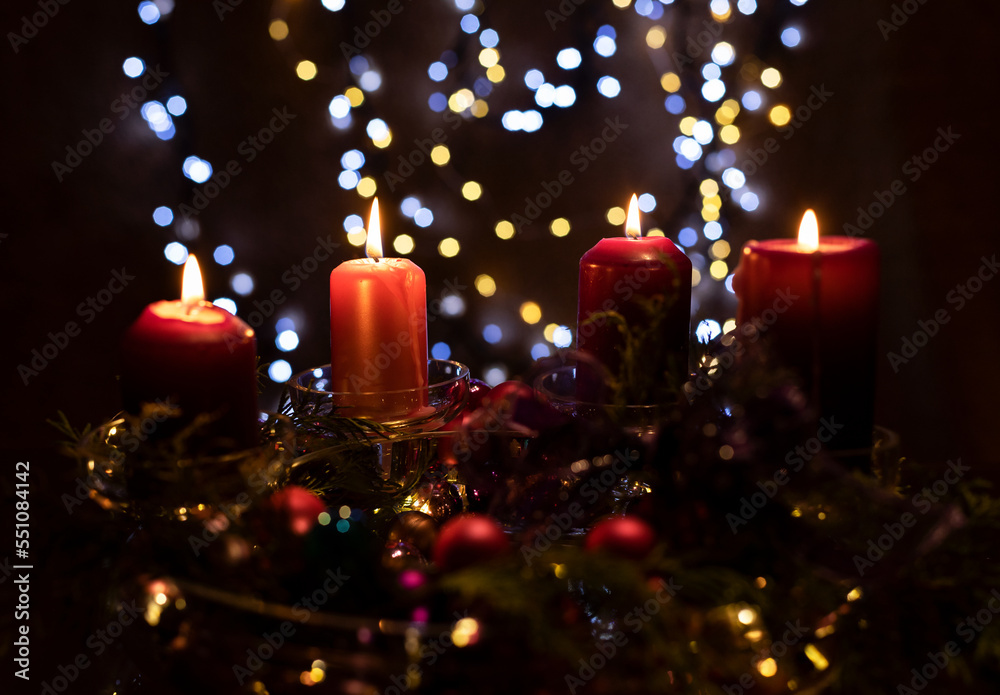 Four candles glow on Advent Wreath. Lighting the fourth candle on the ...