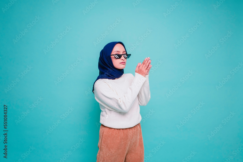Portrait of a cool smiling Asian Muslim woman wearing a glasses ...