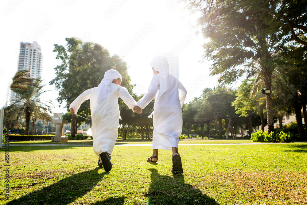 Cute middle eastern kids wearing traditional arab clothing playing and ...