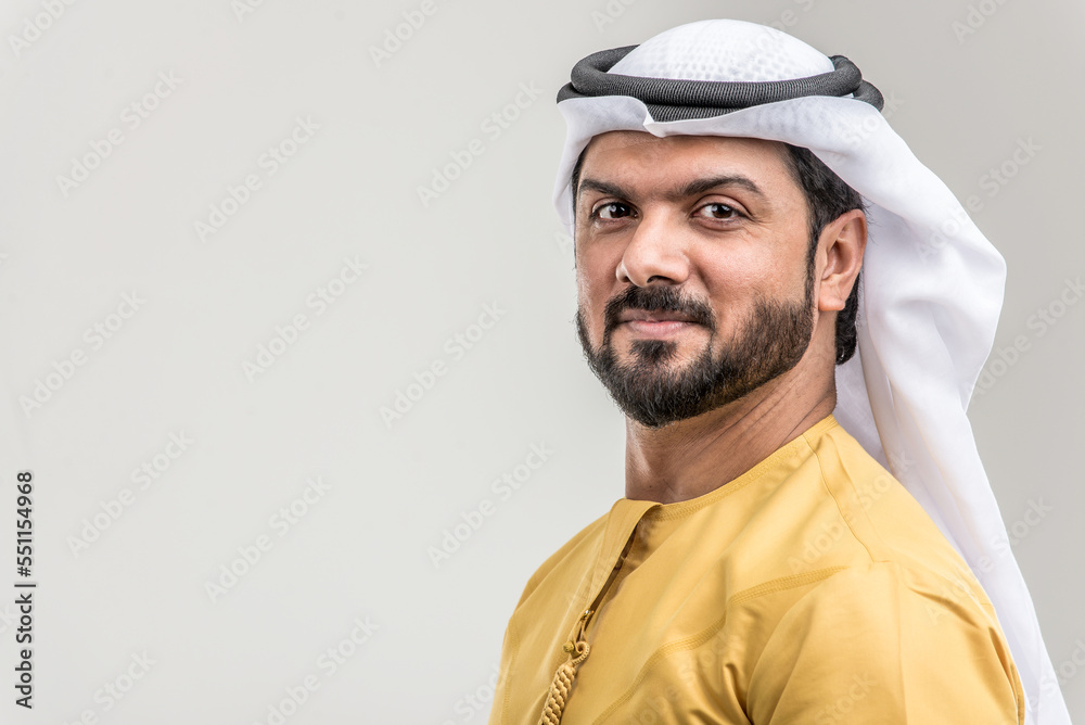 Handsome arab man wearing traditional emirate clothing portrait in ...