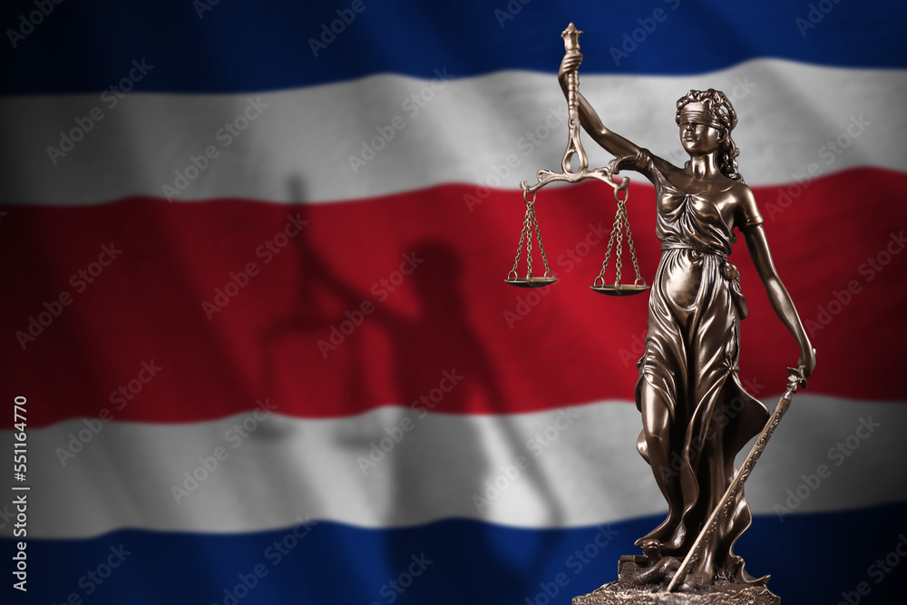 Costa Rica flag with statue of lady justice and judicial scales in dark ...
