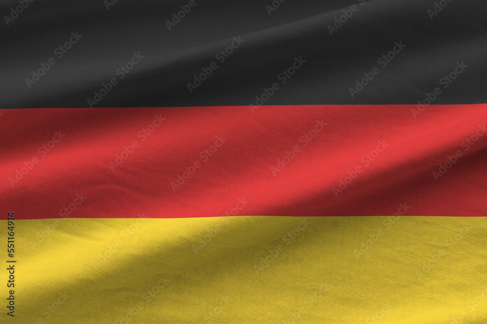 Germany flag with big folds waving close up under the studio light ...