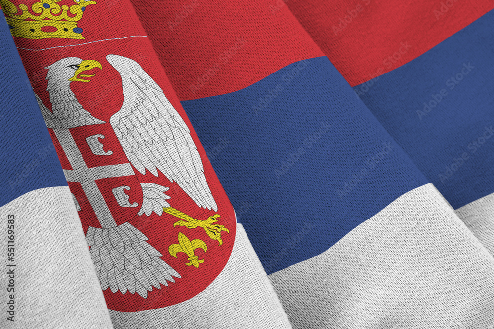 Serbia flag with big folds waving close up under the studio light ...