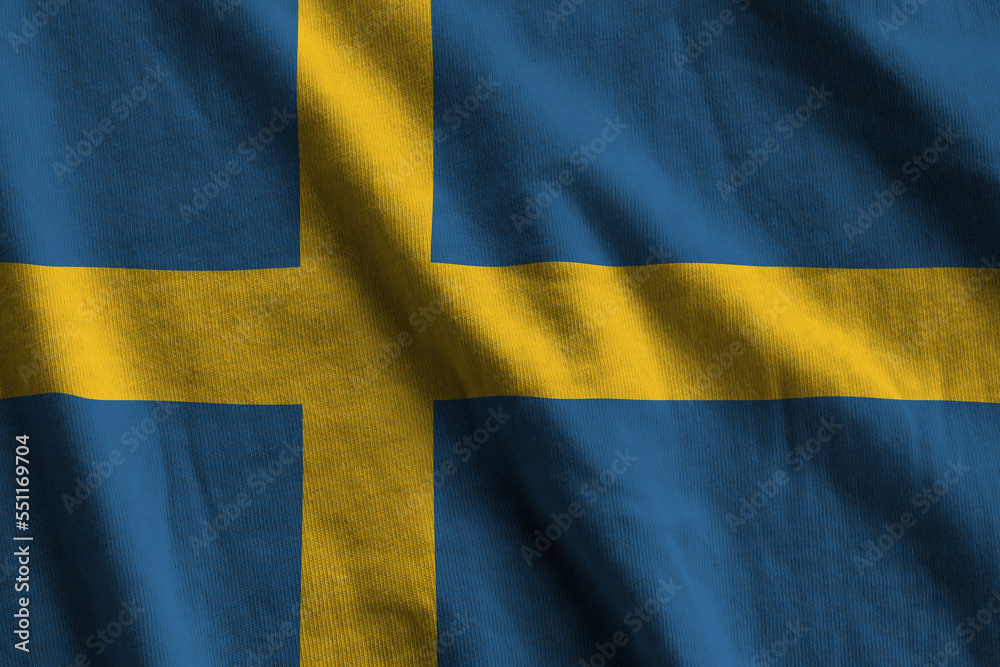 Sweden flag with big folds waving close up under the studio light ...