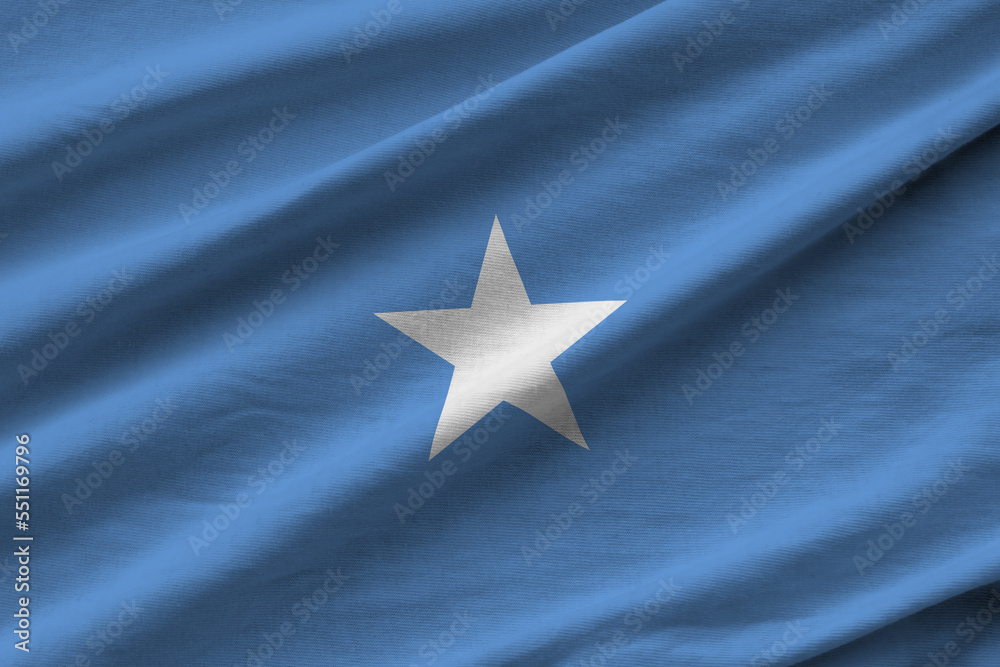 Somalia flag with big folds waving close up under the studio light ...