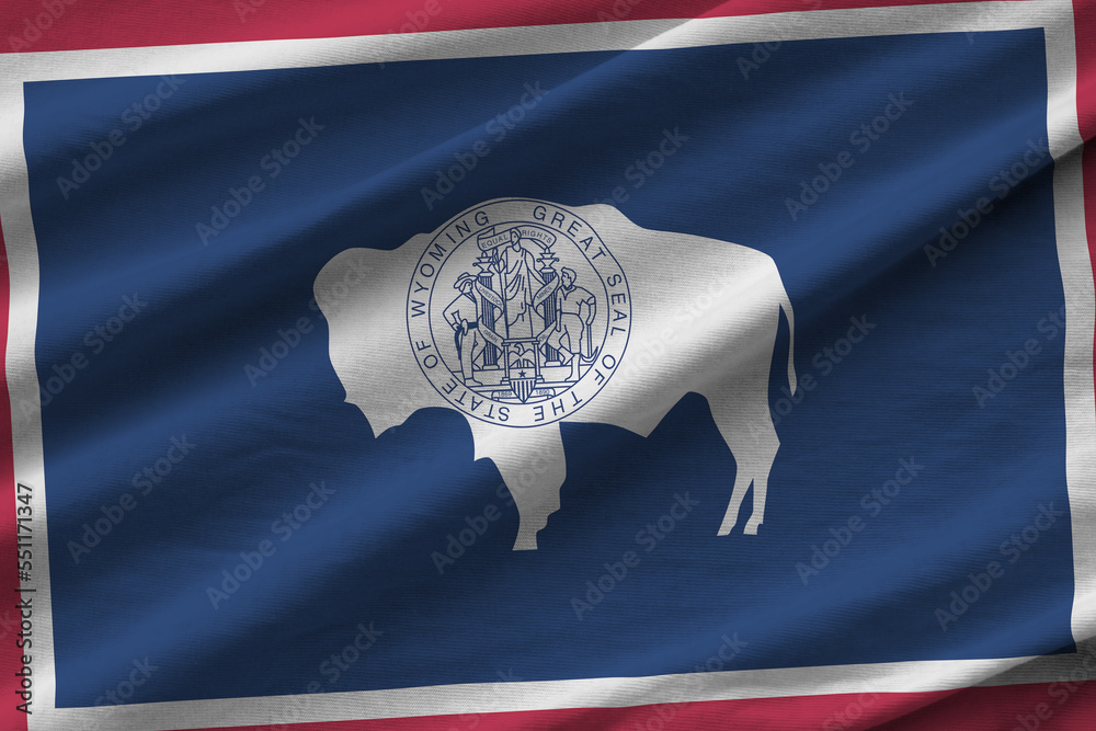 Wyoming US state flag with big folds waving close up under the studio ...