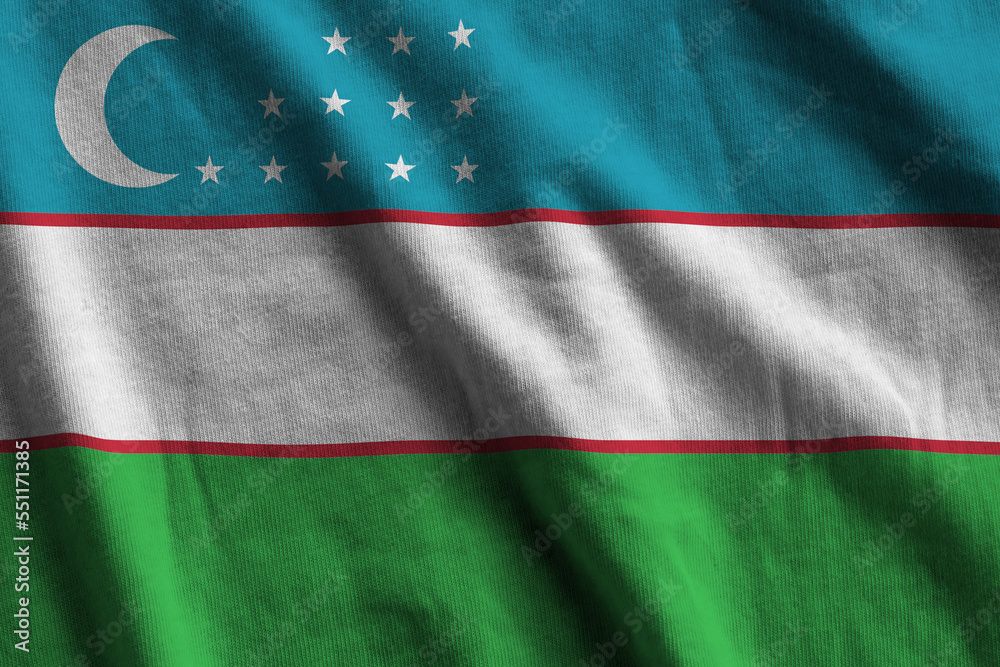 Uzbekistan flag with big folds waving close up under the studio light ...