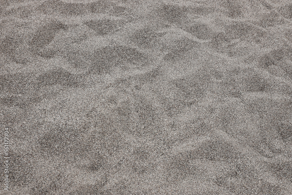 Full frame beach dark sand texture close up in daytime outdoors. Beach ...