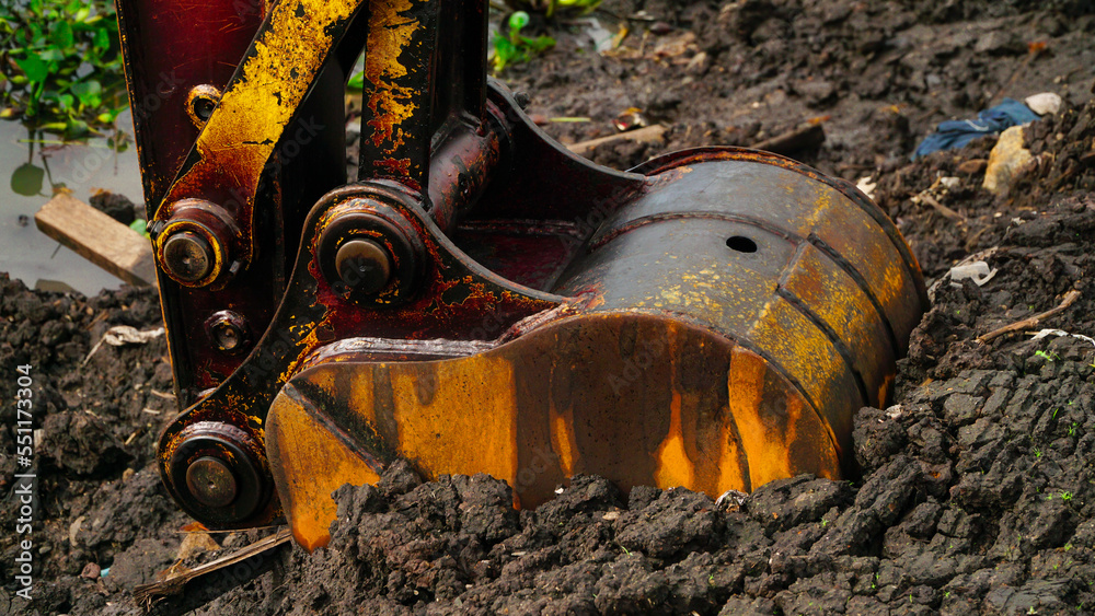 Closeup bucket of backhoe digging the soil. Crawler excavator ...