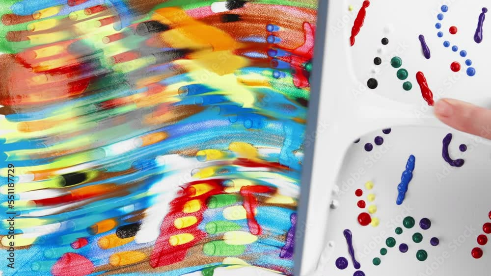 Stockvideon Top view male hand smears mixing multicolor paint droplets ...