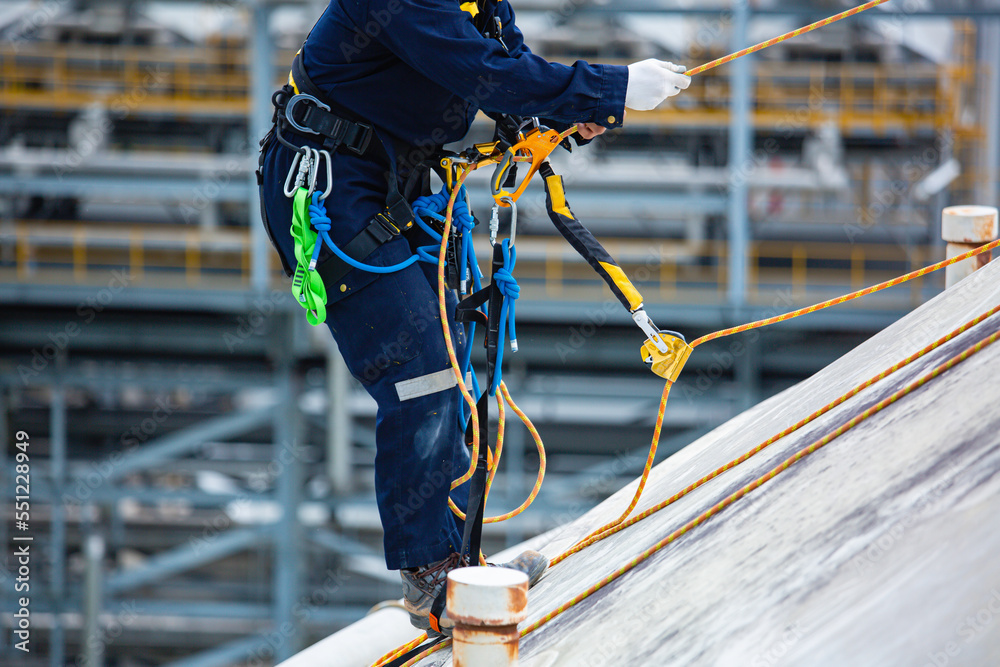 Focus male workers clear rope access wearing safety first harness rope ...