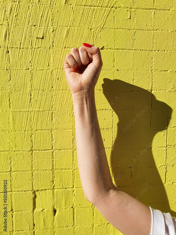 Woman female fist hand with red nails, fist punch air with shadow on ...