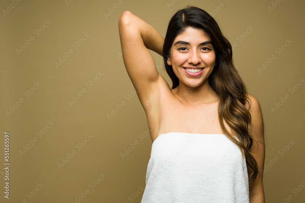 Attractive latin woman showing her smooth armpits after shaving or ...