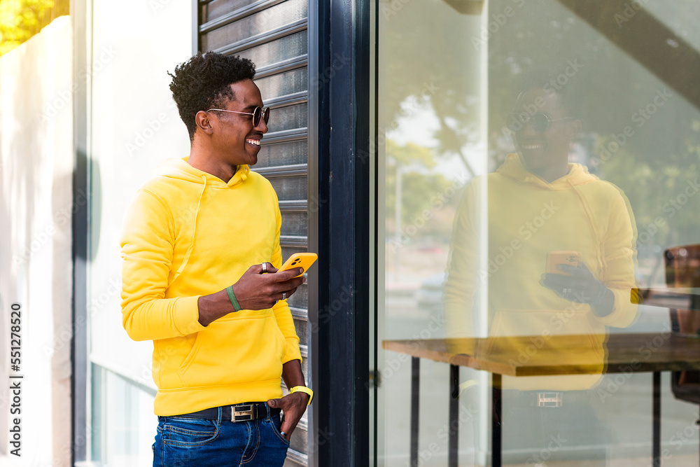 African young man reflected in shop window Stock Photo | Adobe Stock