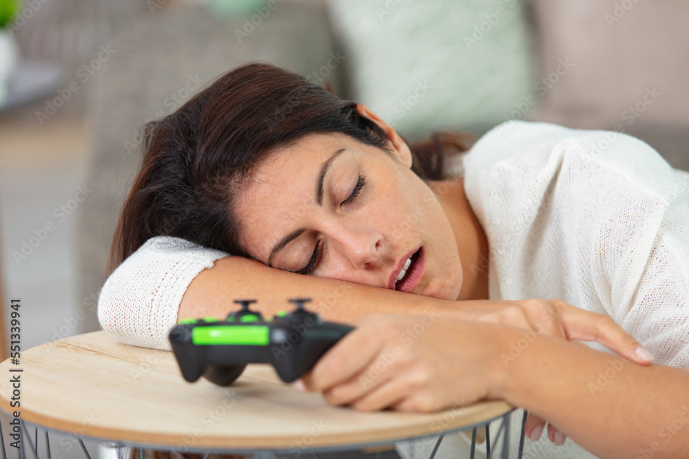 beautiful woman felt asleep playing a video game Stock Photo | Adobe Stock