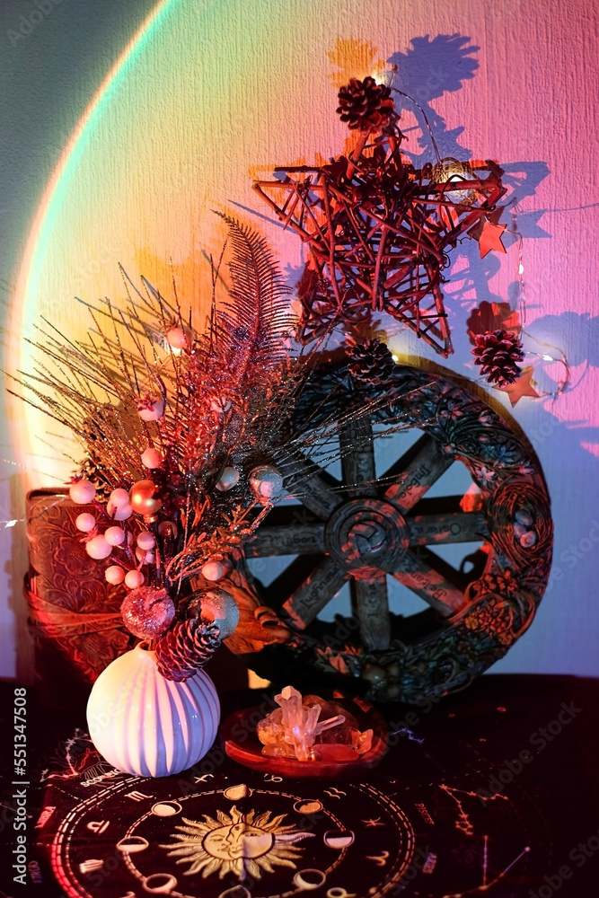 Projecting sunset lamp illuminates a modern witch wiccan altar on table ...