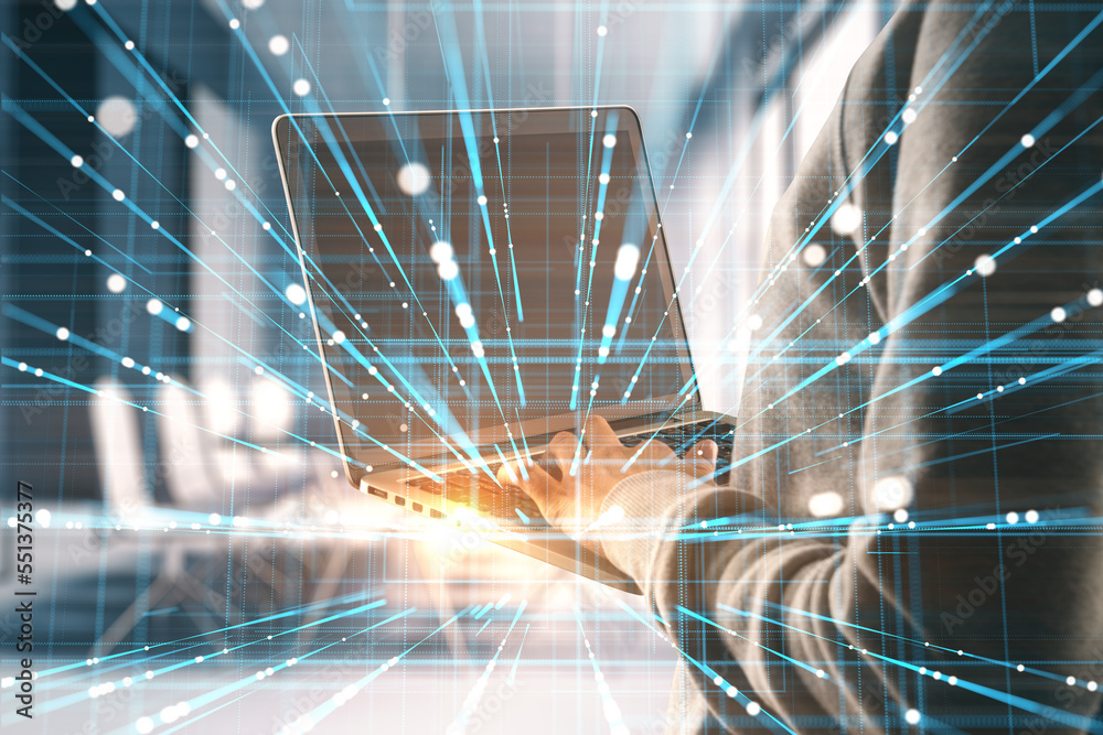 Hacker using laptop computer with creative linear matrix hologram on blurry office interior ...