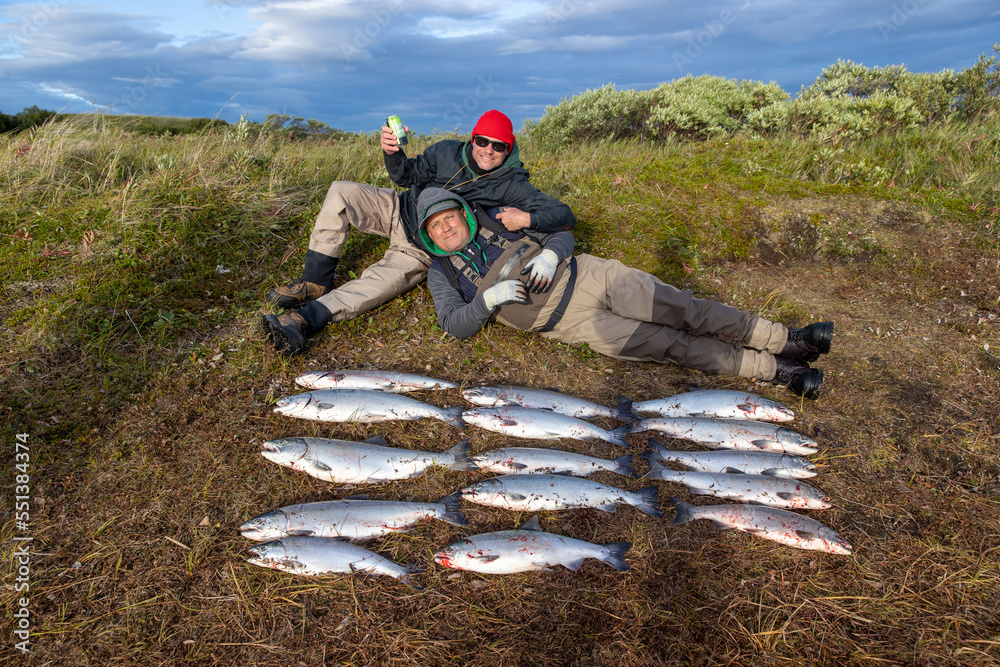 Two men, best friends smile and pose on the Alaskan tundra with a cold ...