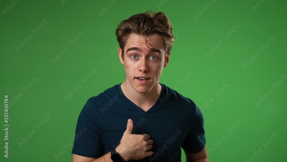 Confused young man 20s posing isolated on green screen background in ...