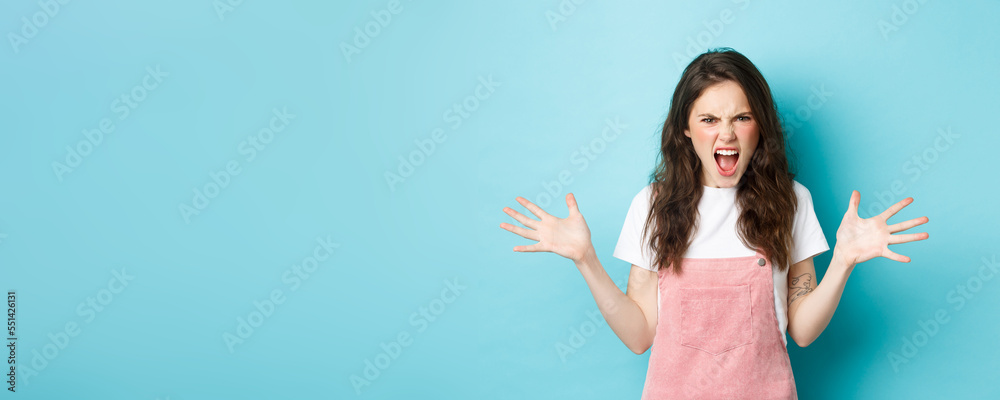 Angry brunette woman in summer outfit, shaking hands and yelling ...