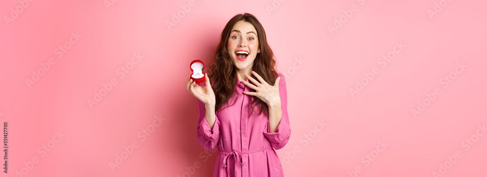 Excited young woman showing engagement ring, getting married, smiling ...