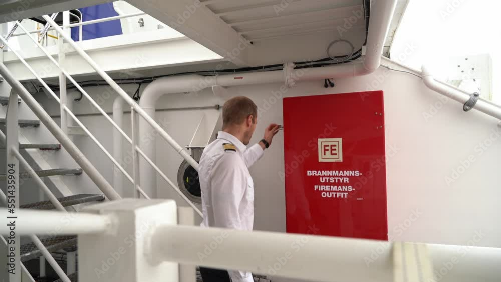 Ship captain inspects firefighting and smokediving equipment onboard ...