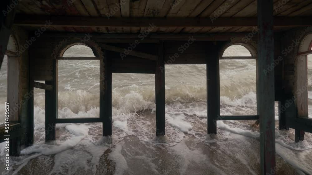Old wooden weathered flooded leaning house interior washed by sea waves ...