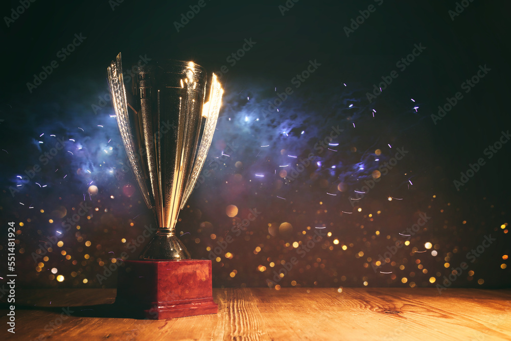 image of gold trophy with sparkly overlay over dark background Stock ...