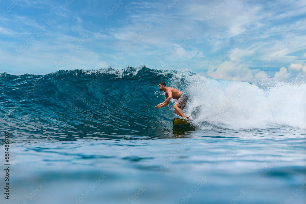 Shirtless male surfer on a wave at sunny day Stock Photo | Adobe Stock