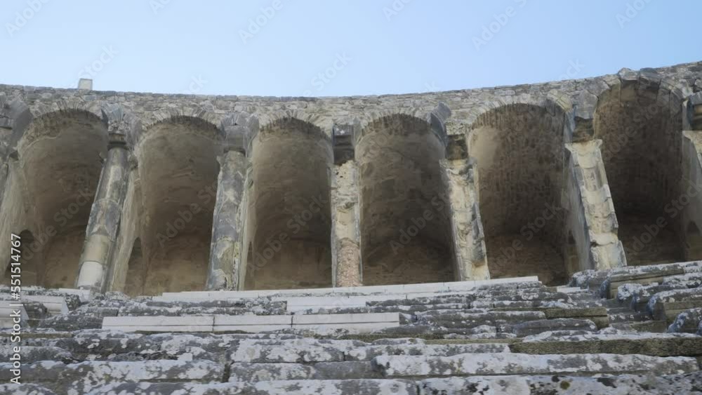 The camera moves along the steps of the seats of the ancient ...