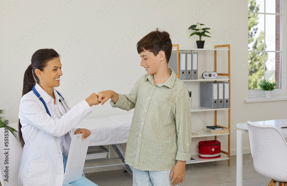 Happy doctor and a child patient greeting each other with a fist bump ...