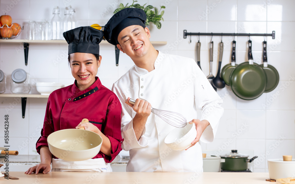 Portrait two young adult Asian professional couple chefs wearing ...
