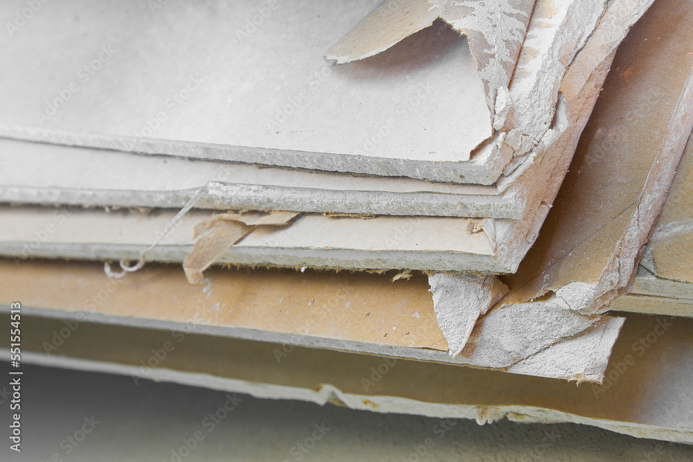 Demolished plasterboard wall, made of plaster and cardboard, with ...