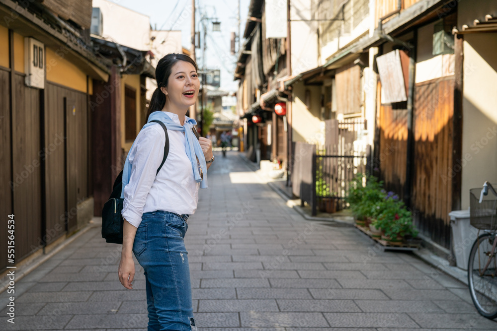 cheerful asian Japanese female tourist turning around and looking at ...