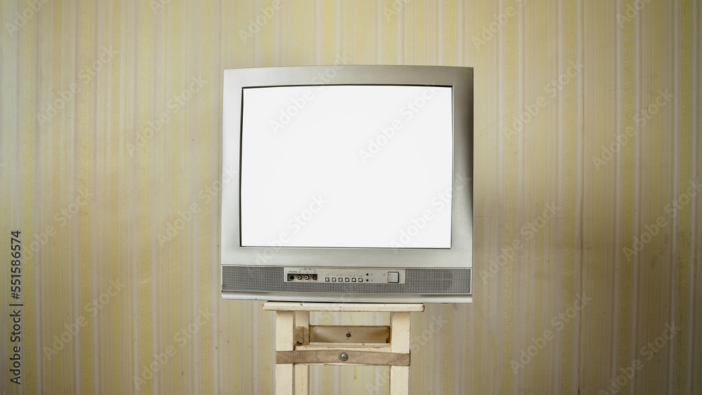Old tv with empty white screen for mockup stands on wooden stool in ...