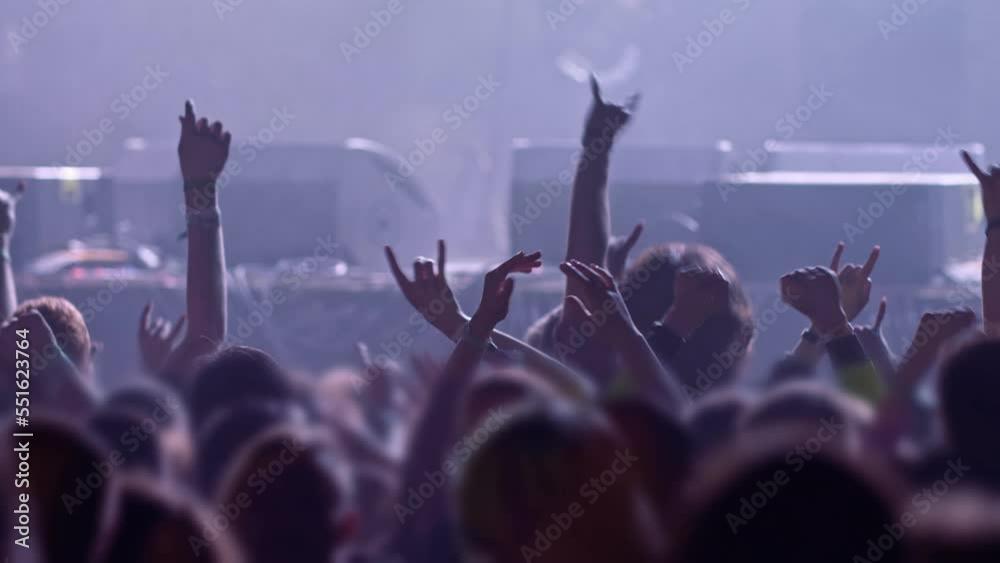 Fans at rock concert. People raising and claping their hands in stage ...