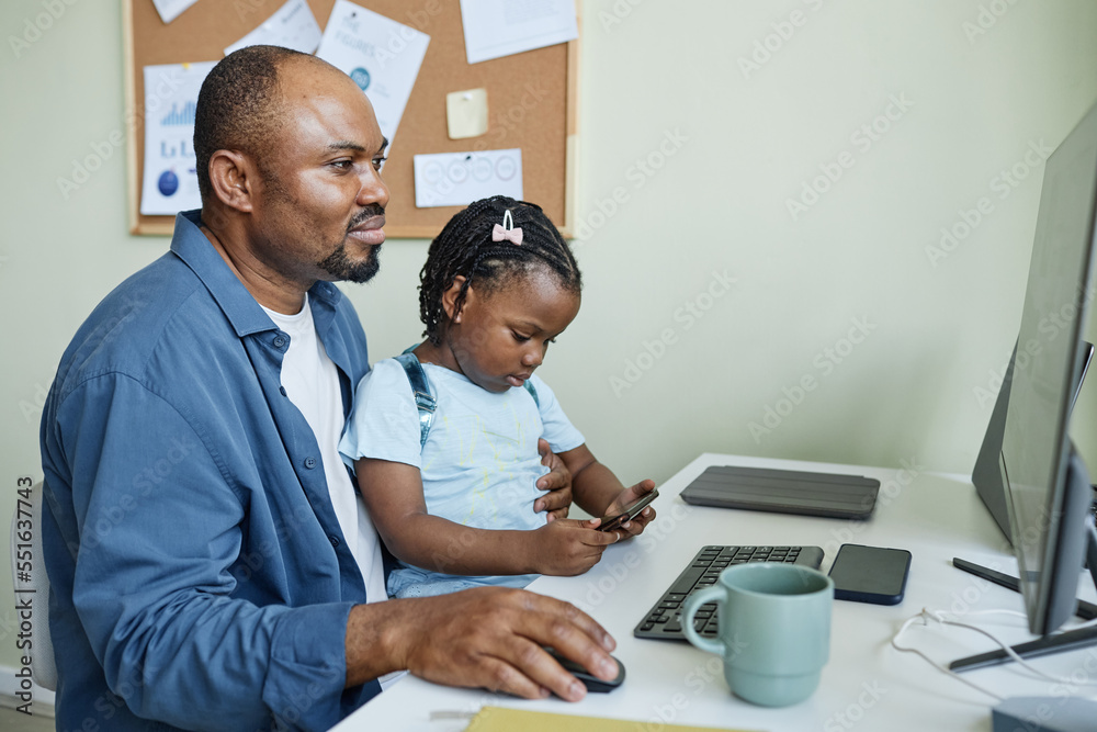 Side view portrait of smiling father with daughter working together in ...