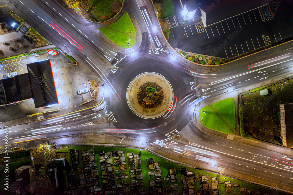 Busy traffic on a roundabout. Top view, light trail photography. Joyce ...