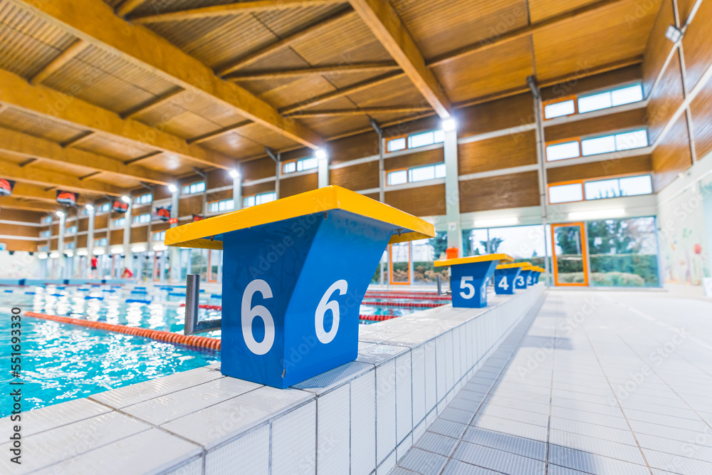 Yellow and dark blue swimming pool starter blocks with big white ...