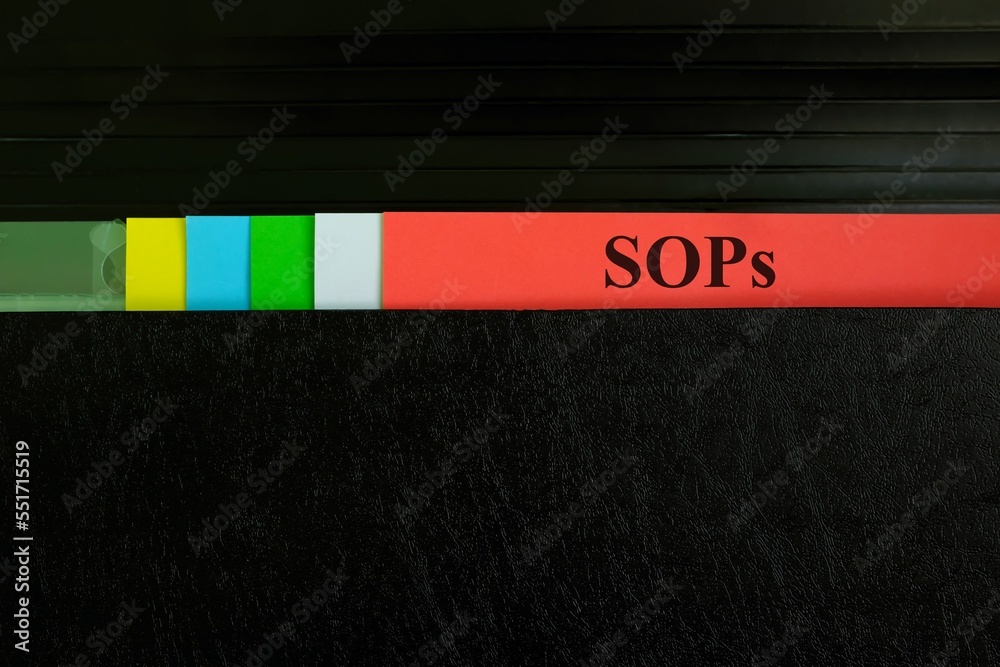 Foto de Hand picking SOP file record in black binder folder. Standard ...