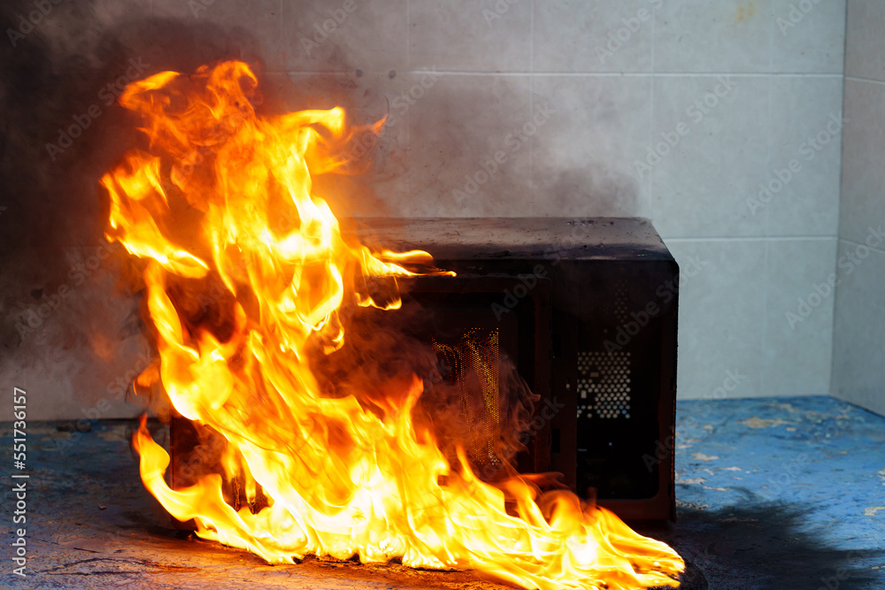 microwave oven on fire. the concept of fire in the kitchen and ...
