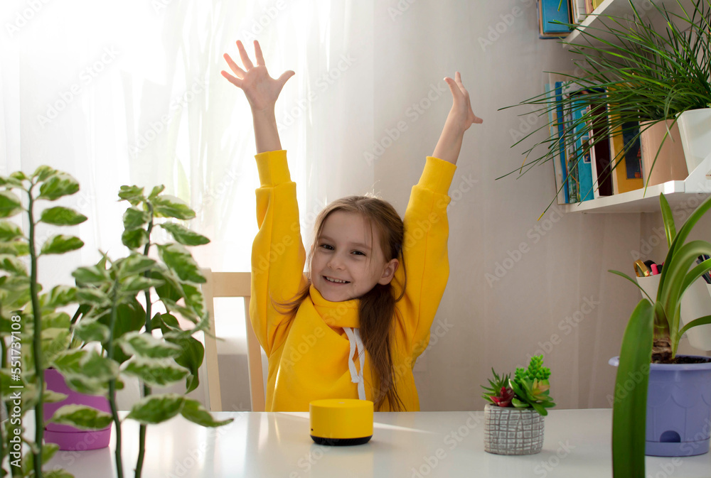 girl talks to Alexa virtual assistant and gives her orders and commands ...