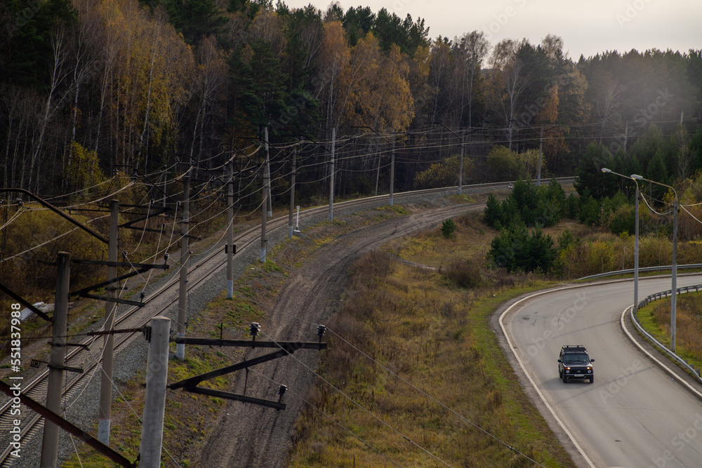 Car driving on road along railroad tracks in forest, trees, forest ...