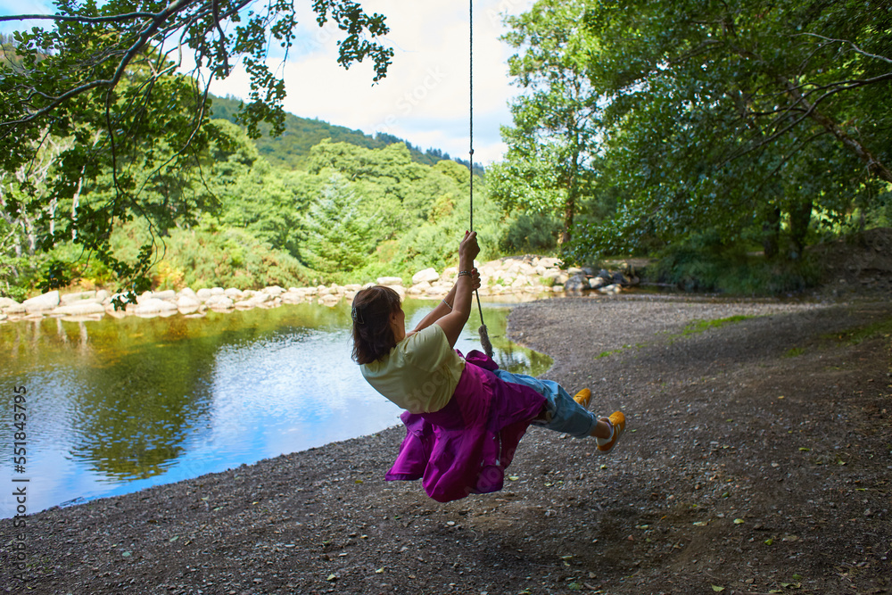Jump into the water. A woman is resting on the lake. A swing from a ...