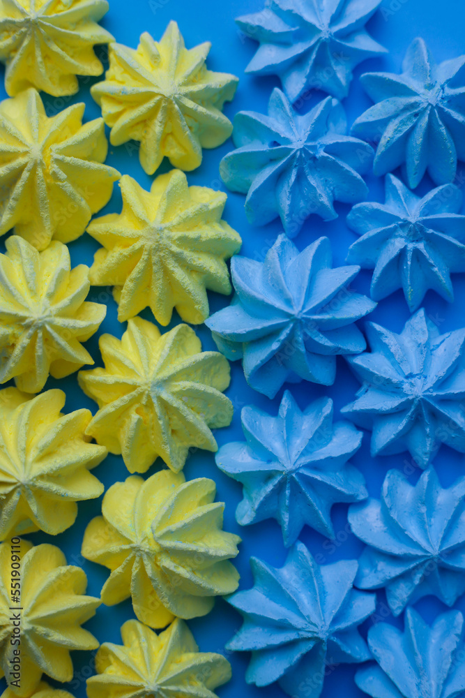 yellow and blue sweet meringue cakes are poured into transparent ...